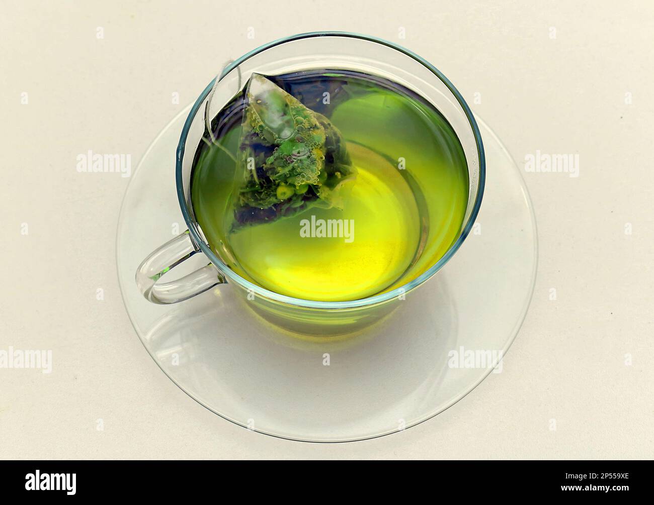 Green jasmine pearls tea bag in glass cup isolated on white background ...