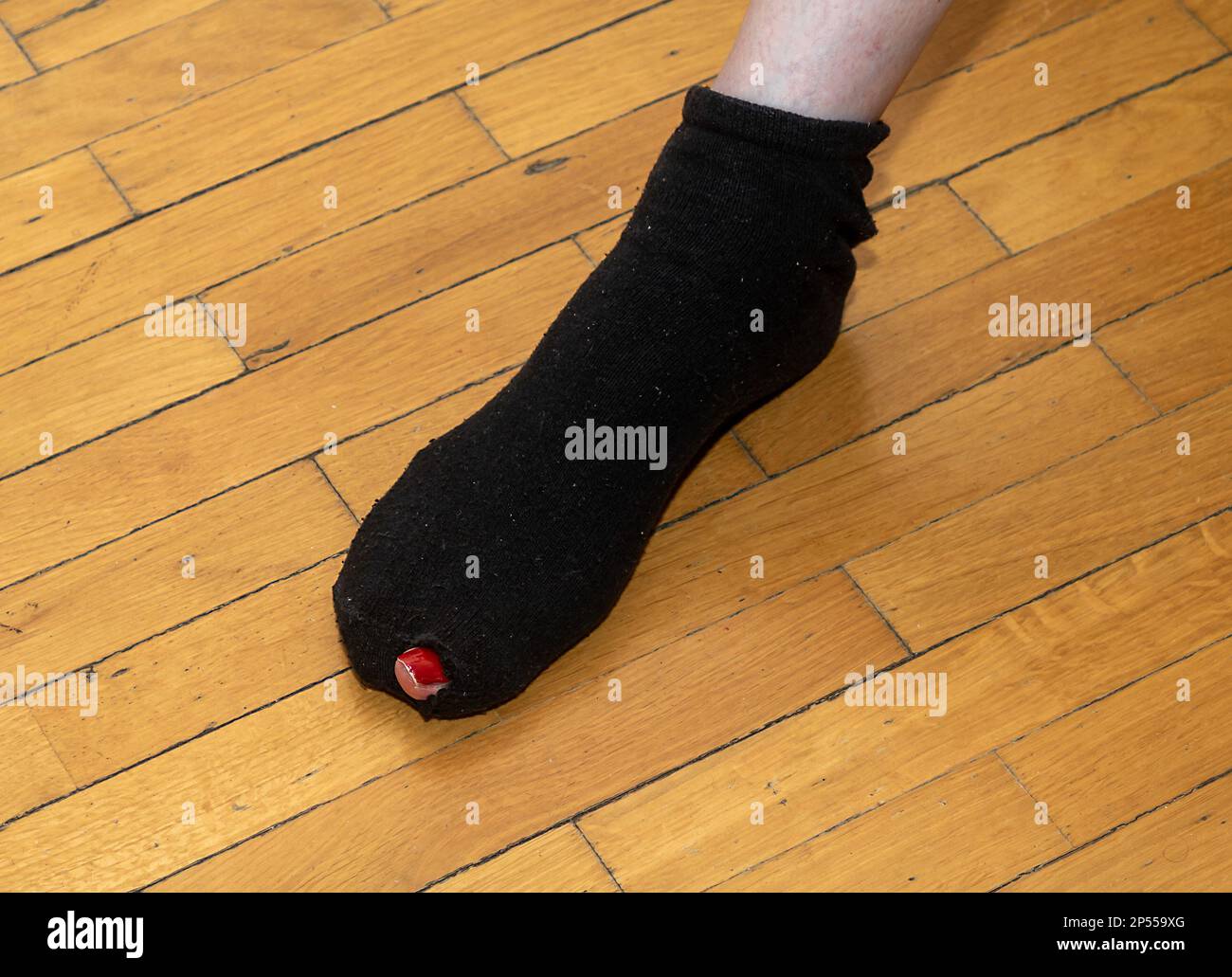 Female foot in ripped sock with big toe sticking out Stock Photo - Alamy