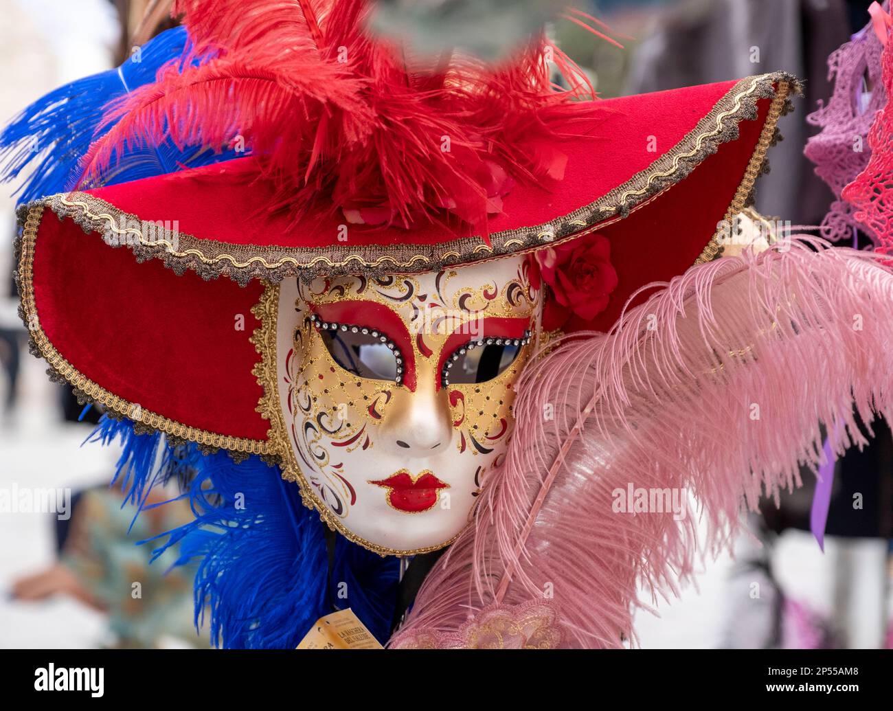 Face mask on display on a street venders stall, Venice, Italy Stock ...