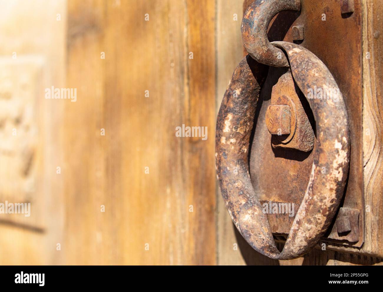 Weathered, aged door knocker beckons on wooden front door in the ...