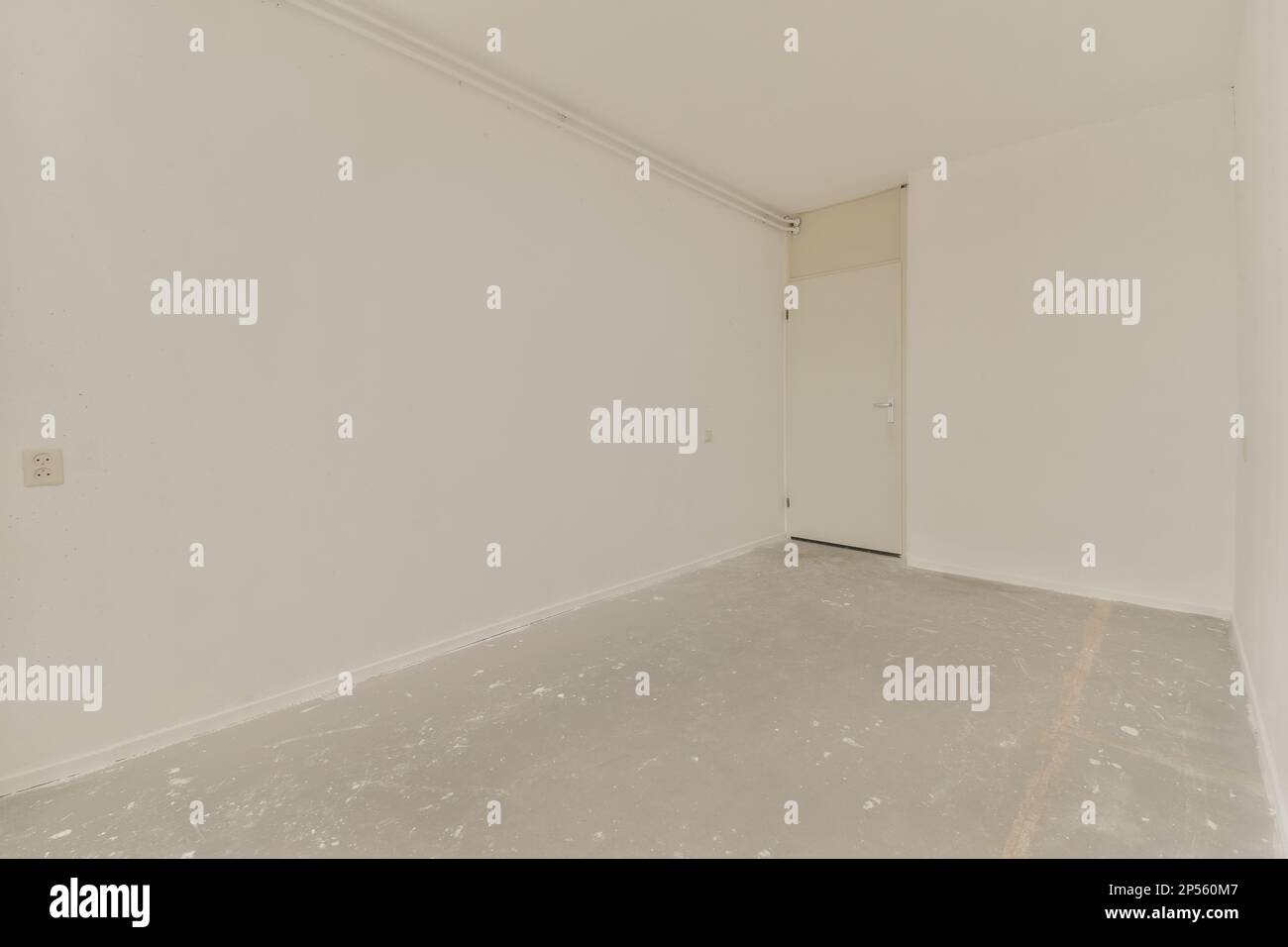 an empty room with white walls and no one person in the room looking at ...