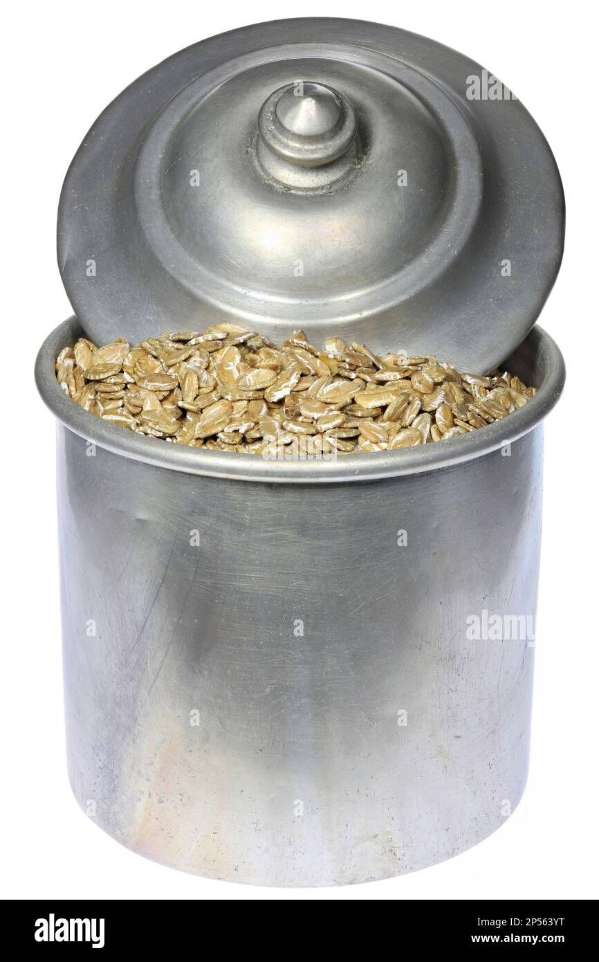 rye flakes in an aluminum jar isolated on white background Stock Photo ...