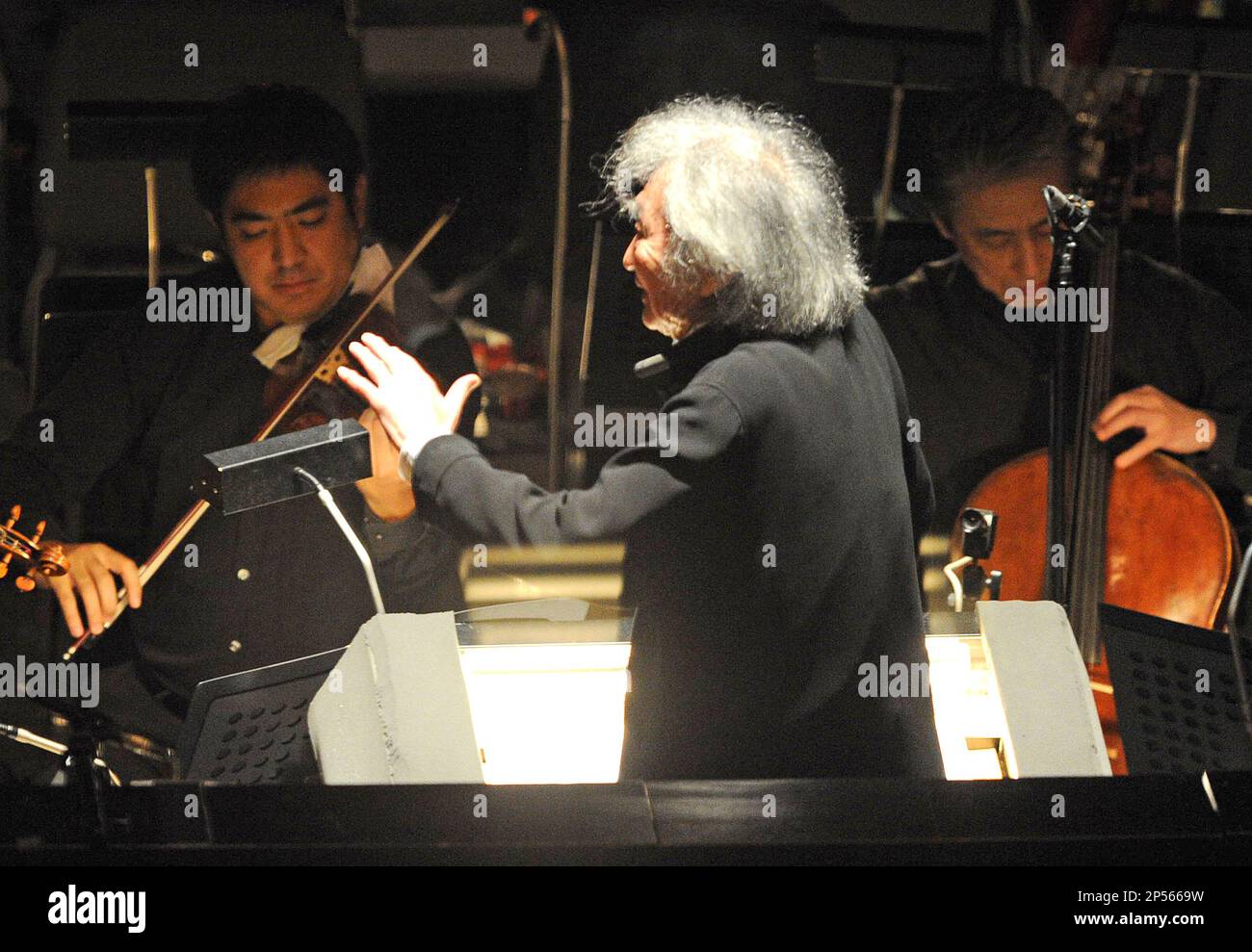 Japanese world-renowned conductor Seiji Ozawa coducts a baton during ...