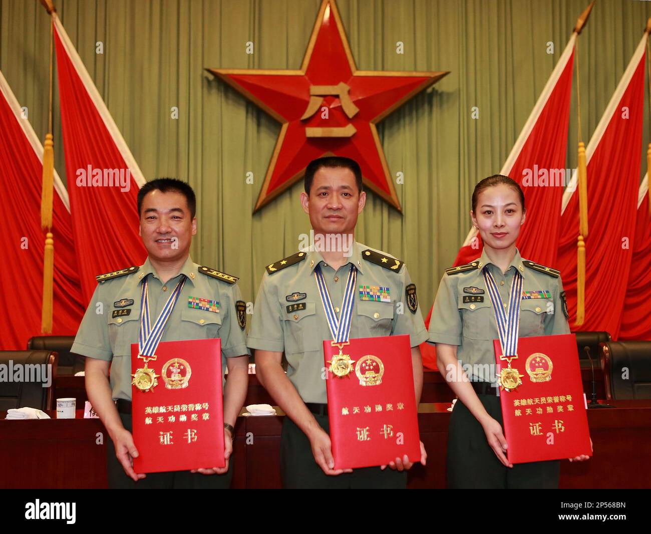 Chinese Shenzhou-10 mission astronauts Wang Yaping (R), Nie Haisheng (C ...
