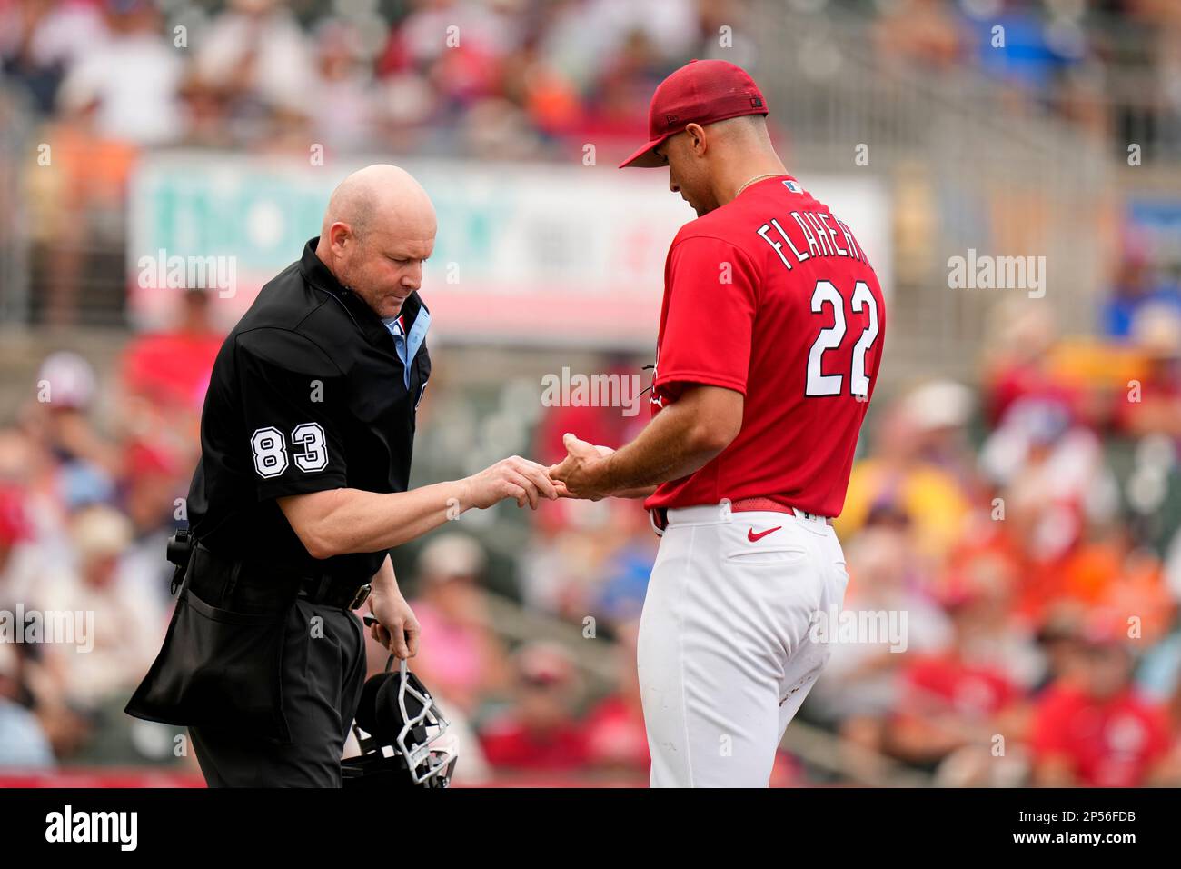 Home plate umpire Mike Estabrook (83) inspects the hands of St. Louis ...