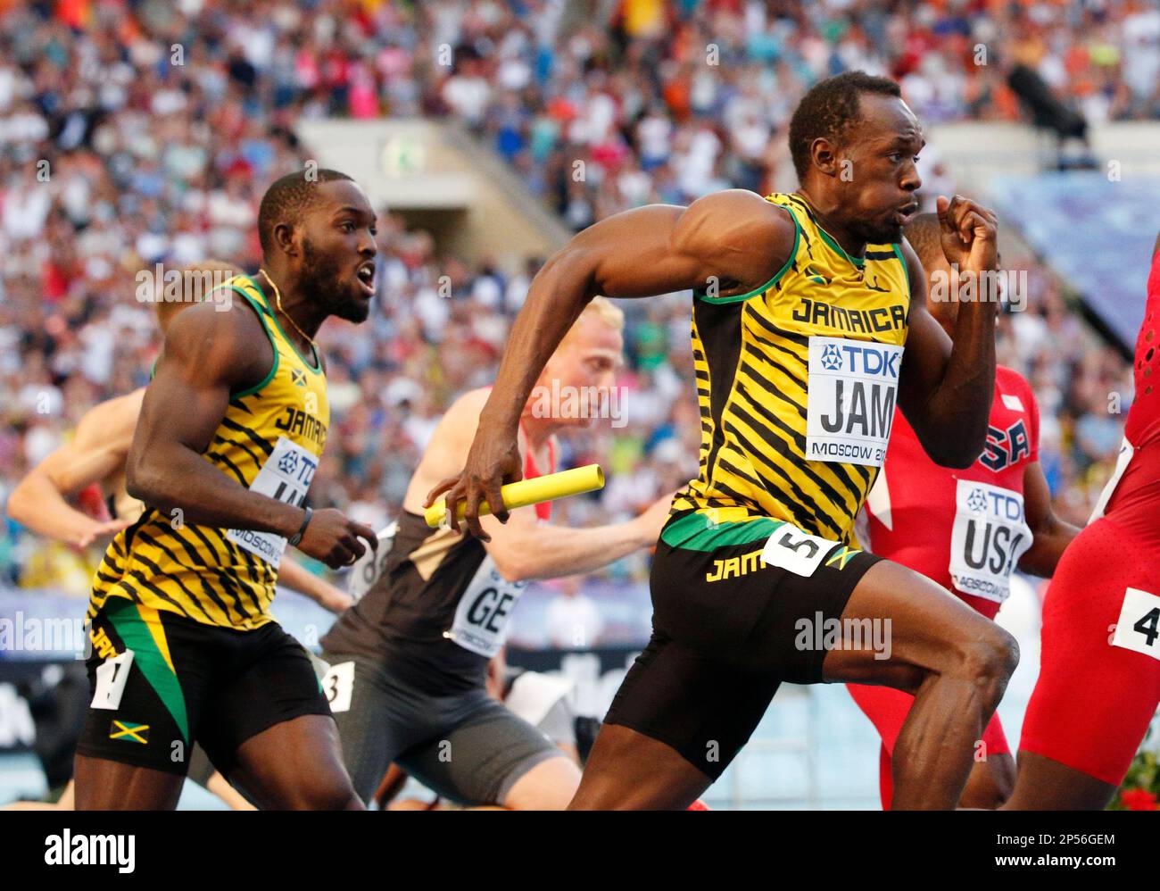 Jamaica's Usain Bolt, right, runs ahead of Jamaica's Nickel Ashmeade, left, after receiving the ...