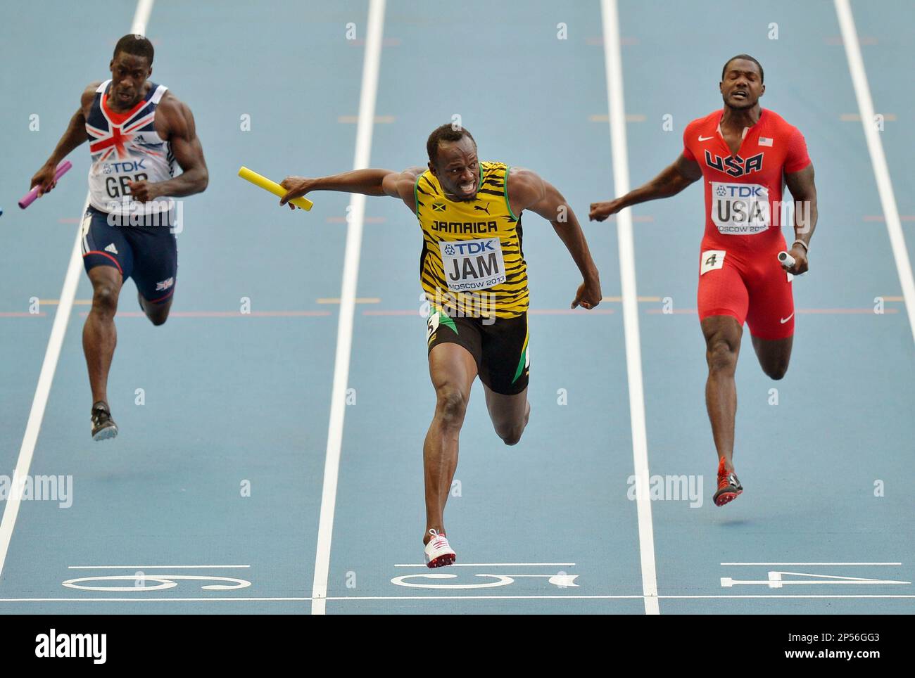 Jamaica's Usain Bolt, center, crosses the finish line to win ahead of ...