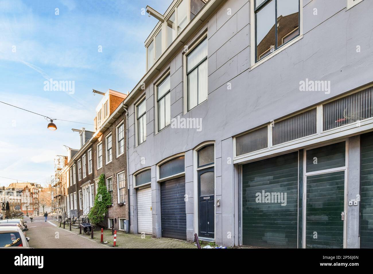 a city street with cars parked on the side of the road in front of an ...