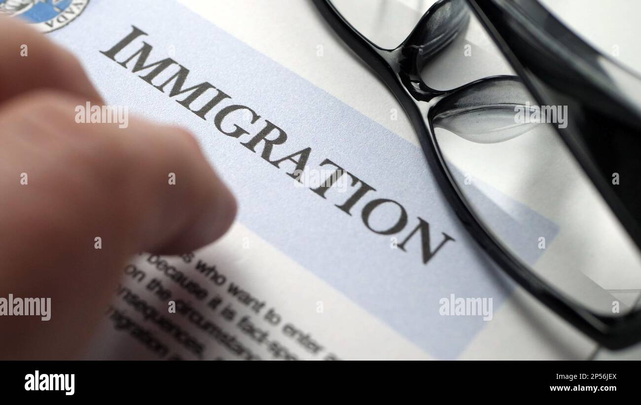 Finger tapping on immigration document Stock Photo - Alamy