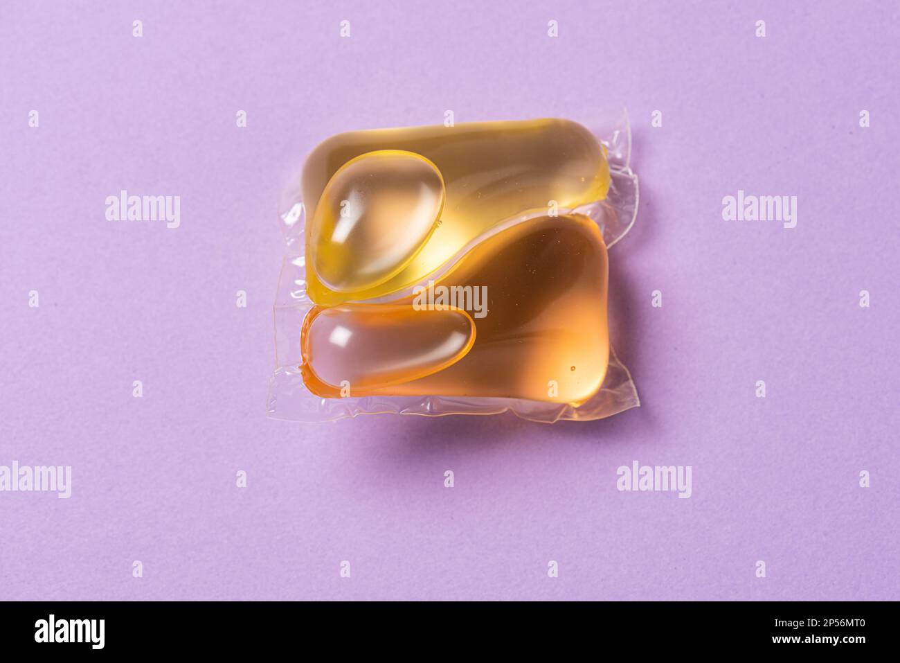 Liquid clothes detergent in water soluble packaging Stock Photo - Alamy