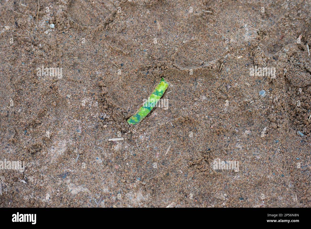 Slice of watermelon partly hidden in sand at a beach Stock Photo - Alamy