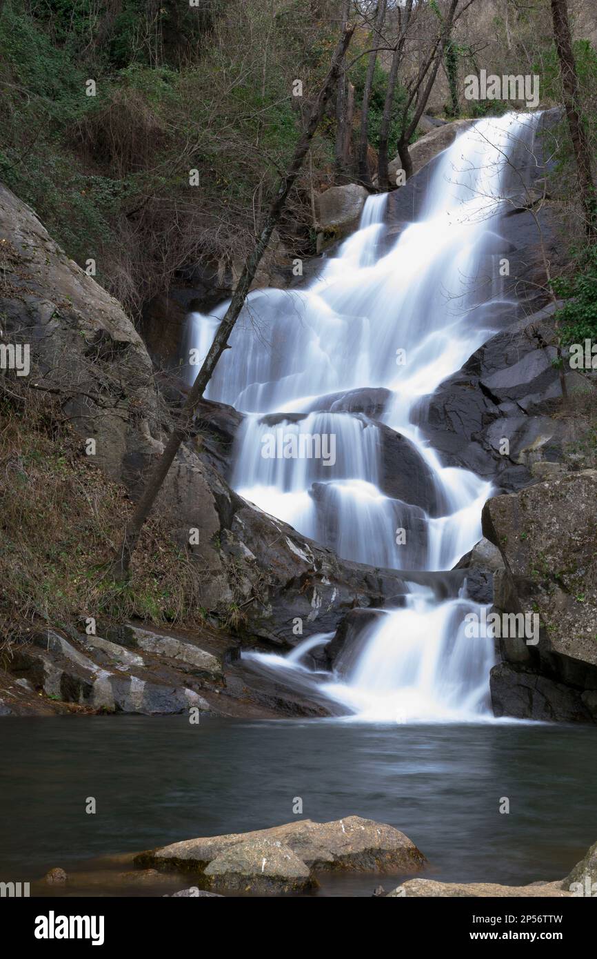 river with falling water in long exposure in winter in vertical Stock ...