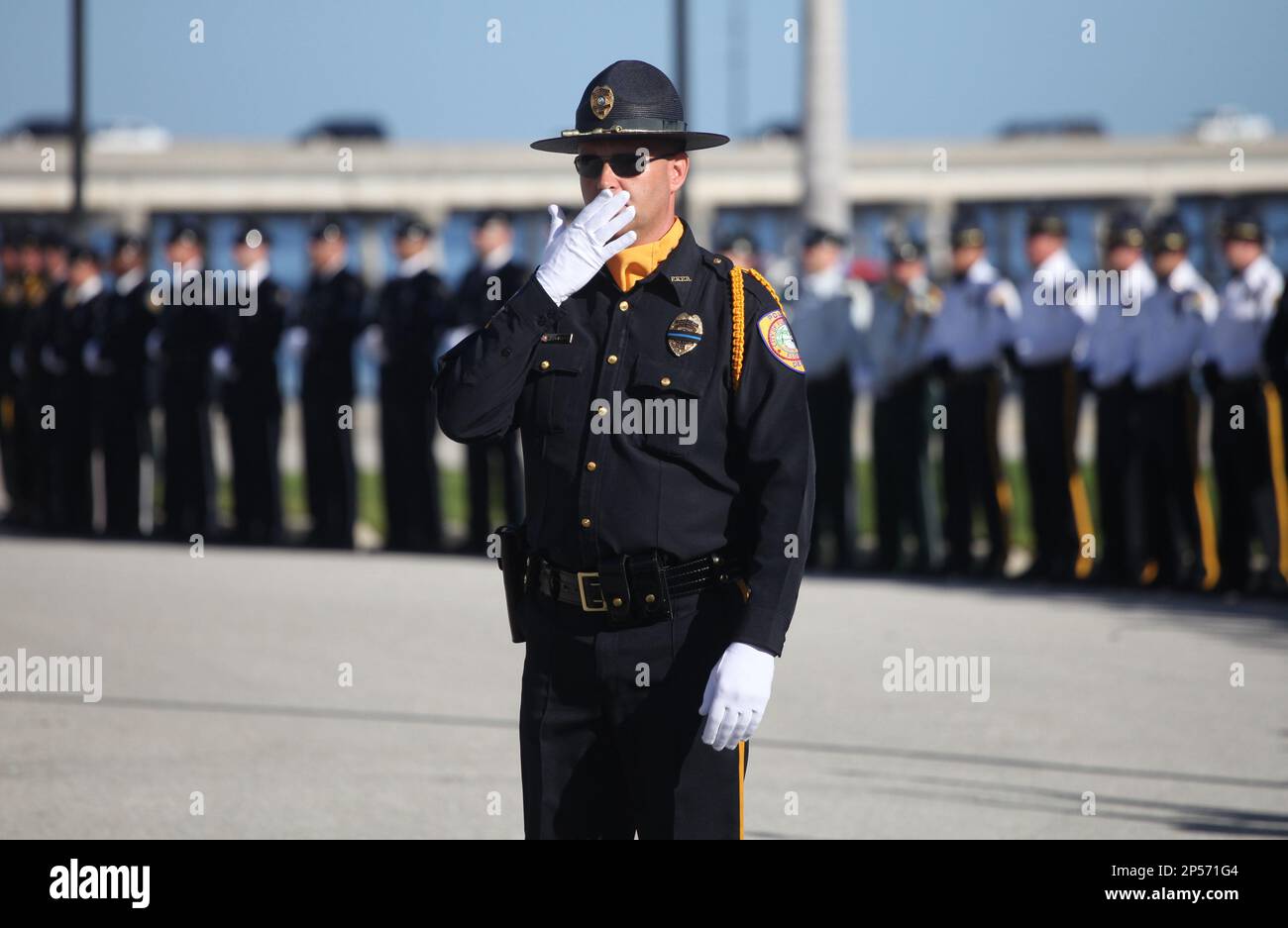 Tony Pribble, of the Punta Gorda Police Department, pauses to wipe his ...