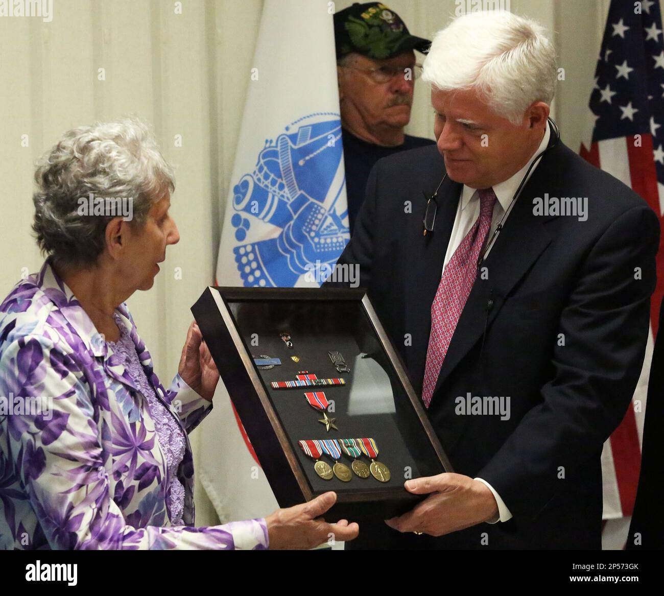 Norma Palmquist, left, wife of WWII veteran Runo Palmquist, receives ...