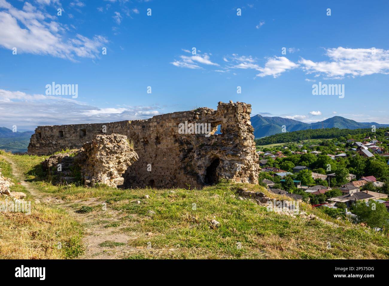 Surami fortress grass courtyard with ruins of stone defense wall ...