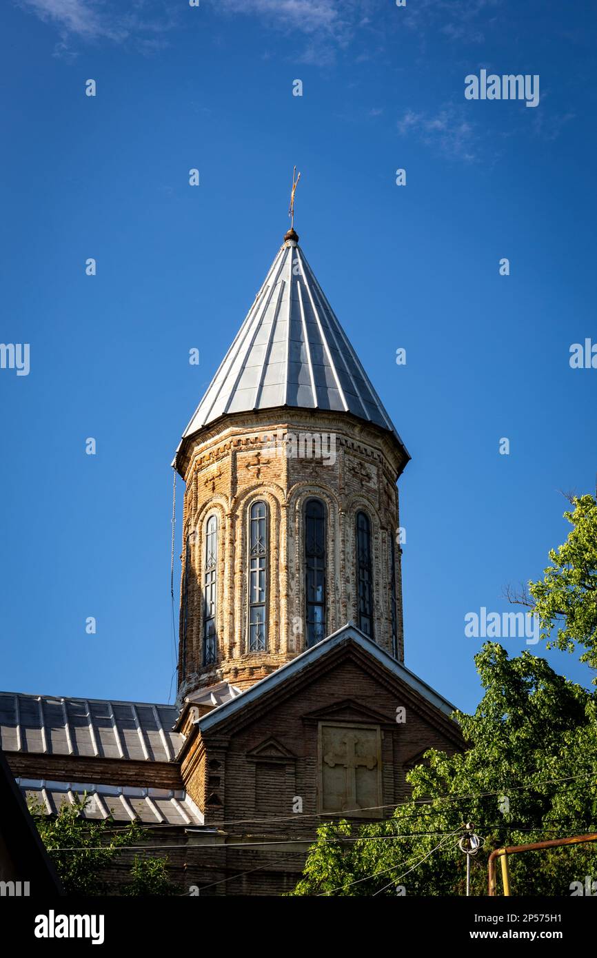 Old medieval bell tower (belfry) against blue sky, Church of Saint ...