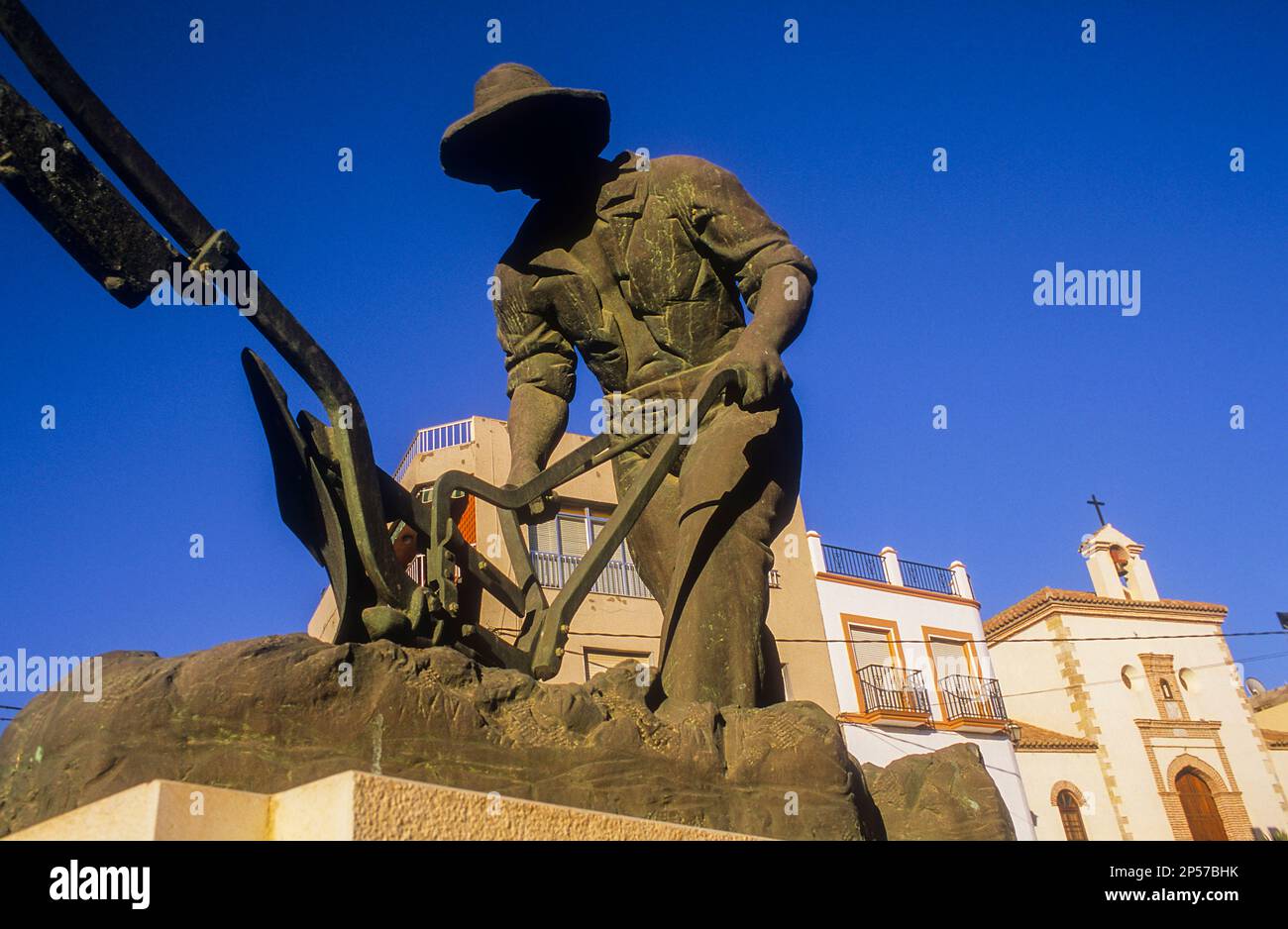 Monument to the farmer, in background hermitage of San Sebastián, Adra ...