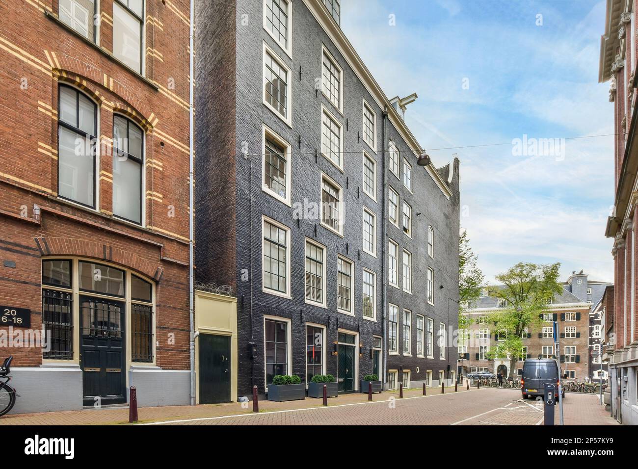 a city street with buildings and people walking on the sidewalk in ...