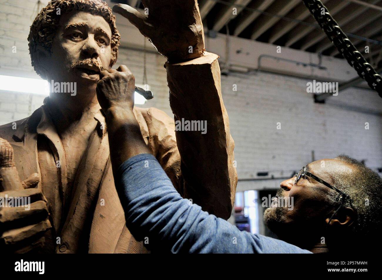 In this June 10, 2013 photo, artist Preston Jackson uses a butter knife ...