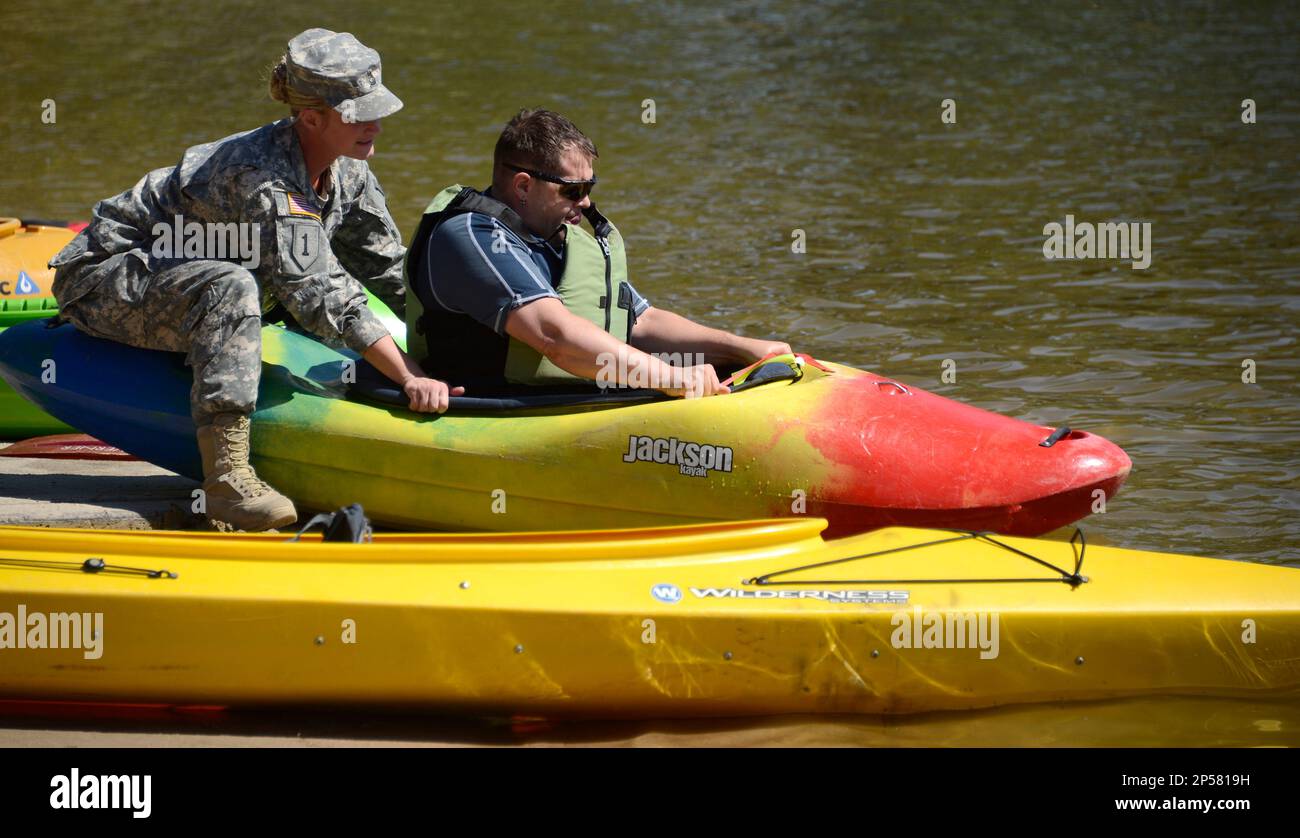 Sgt 1st Class Dionna Bailey helps C.J. Shunk get situated in his kayak ...