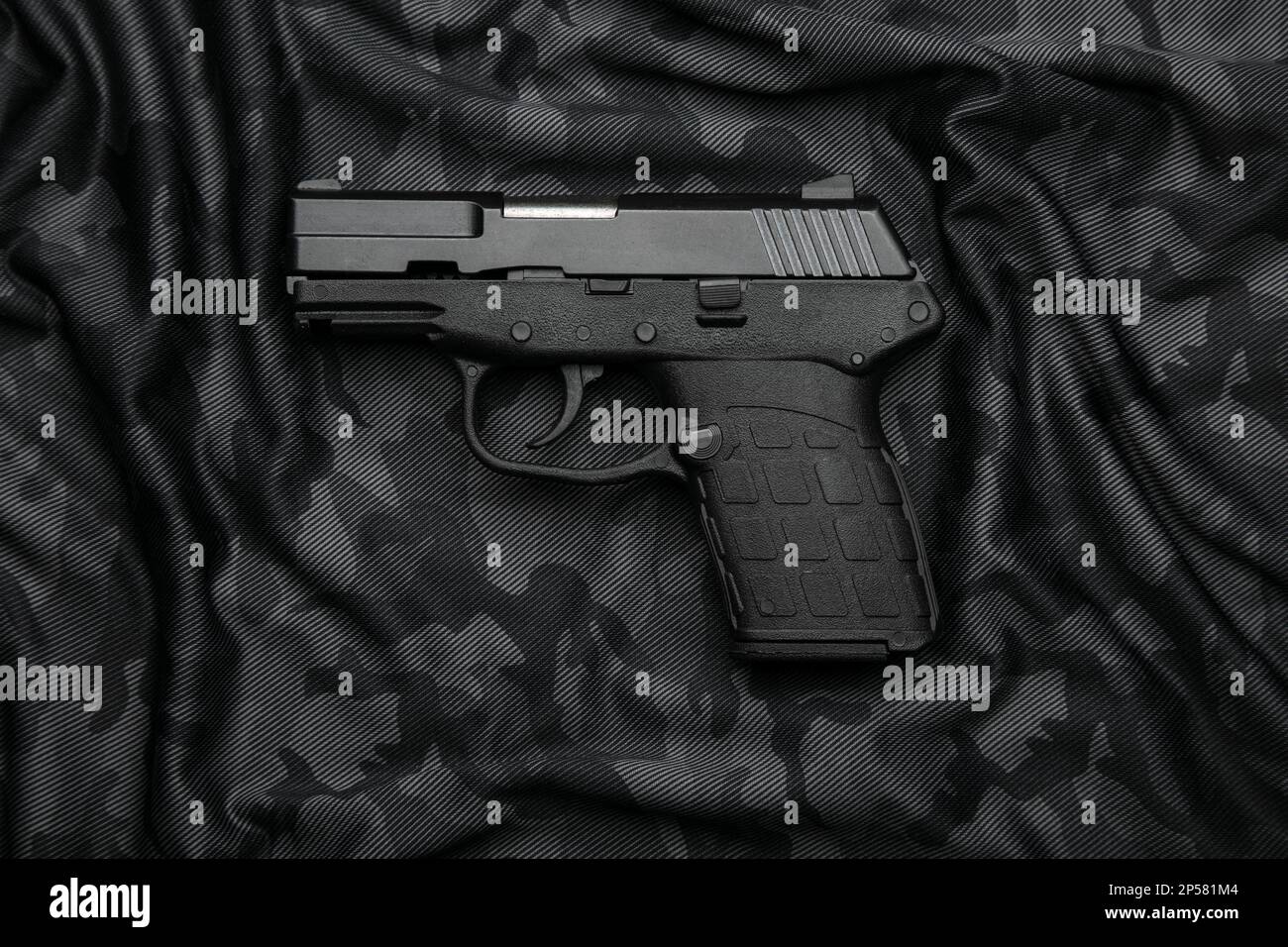 Modern semi-automatic pistol isolate on a camouflage background ...