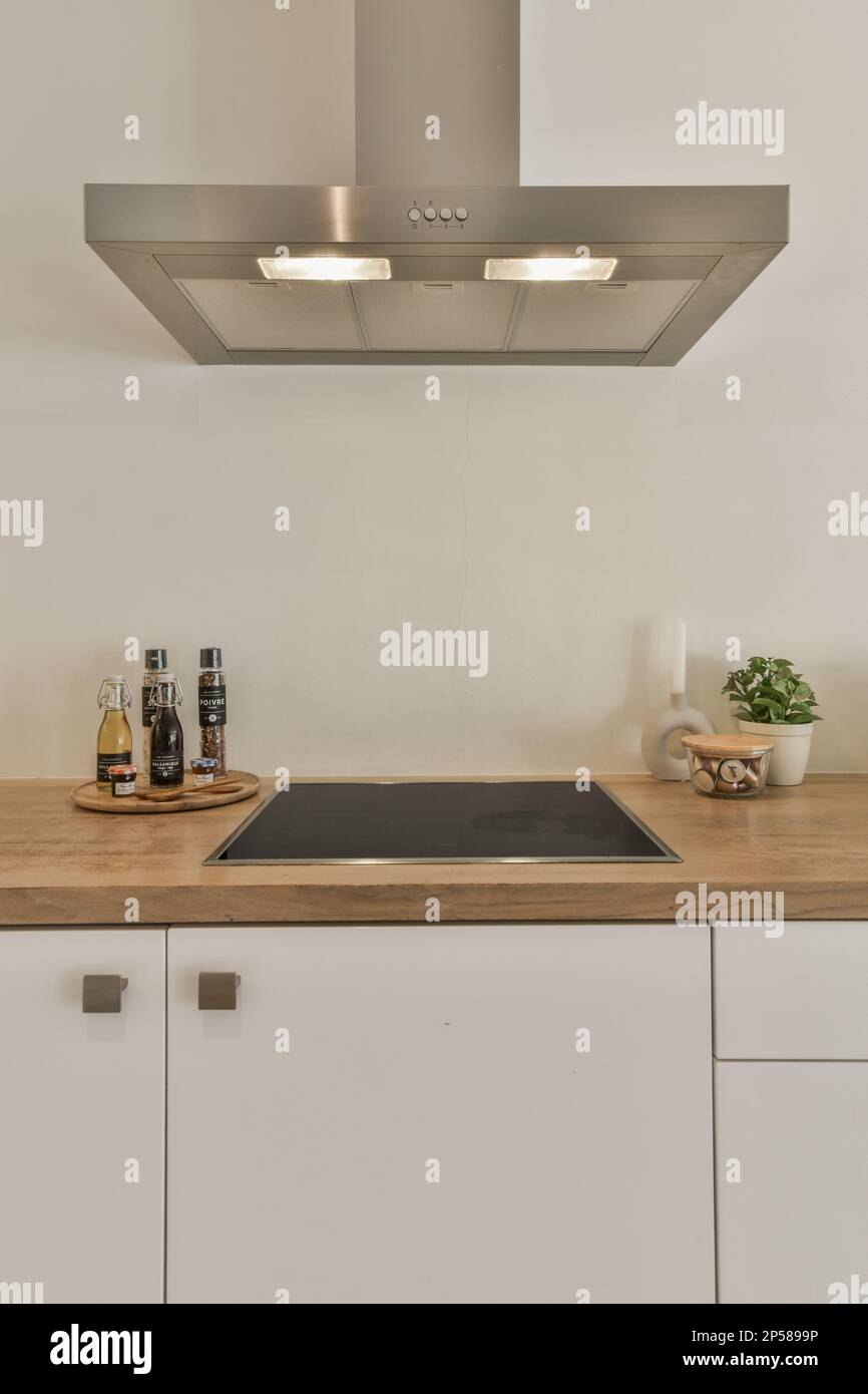 a kitchen with white cupboards and wood counter tops on the wall above ...