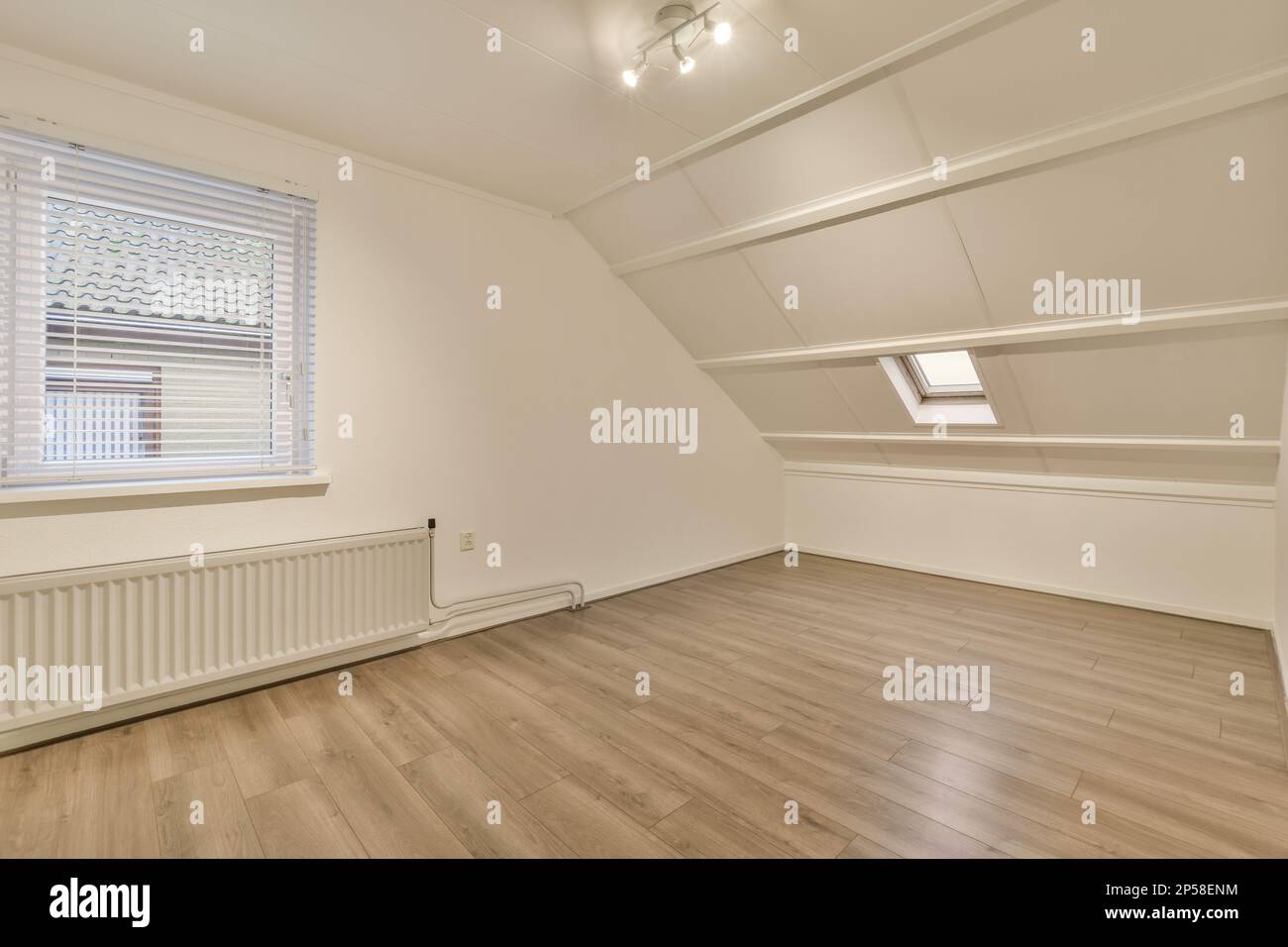 an empty room with white walls and wood flooring, there is a rad in the ...