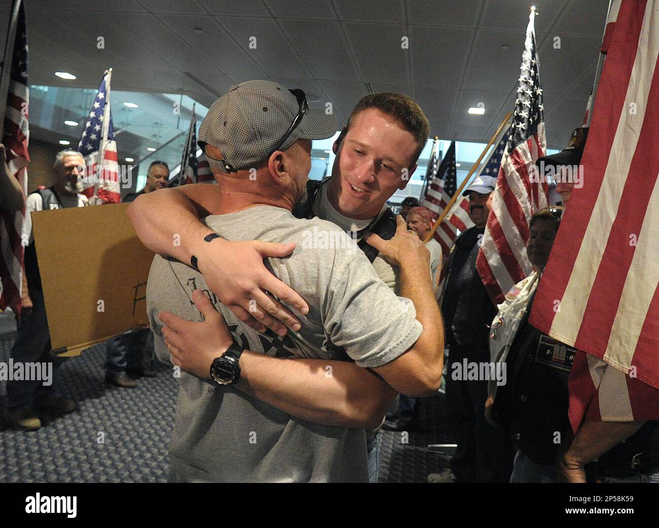 U.S. Army Sgt. Joel Hummer, of Phillipsburg, hugs his father John ...