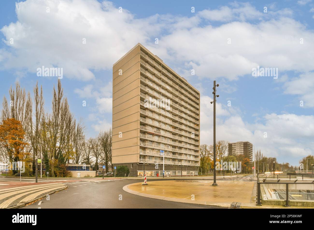 a very big building in the middle of an urban area with some trees and ...