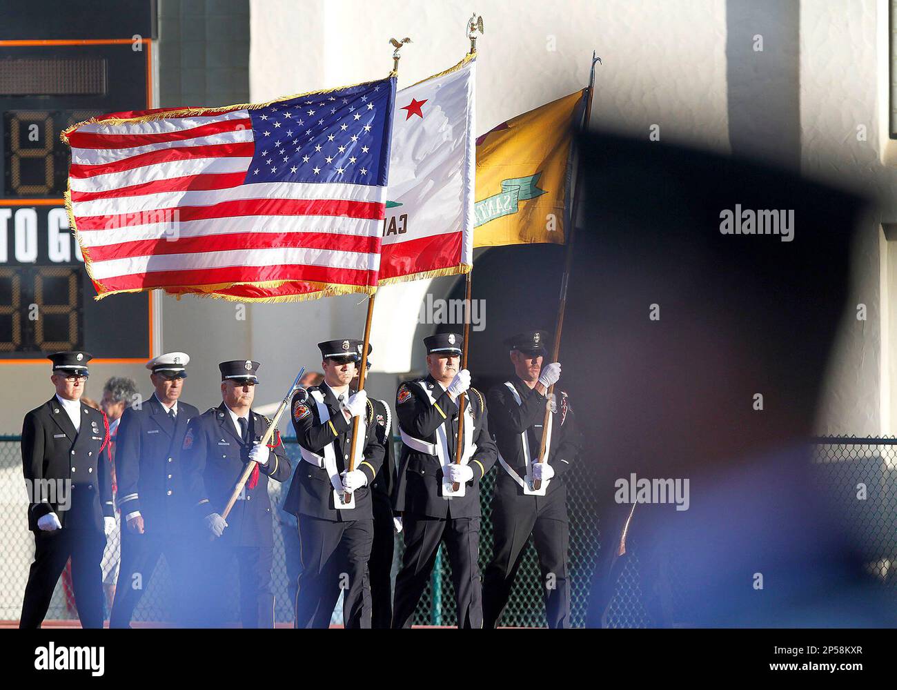Santa Barbara City Fire and Ventura County Fire firefighters carry the ...