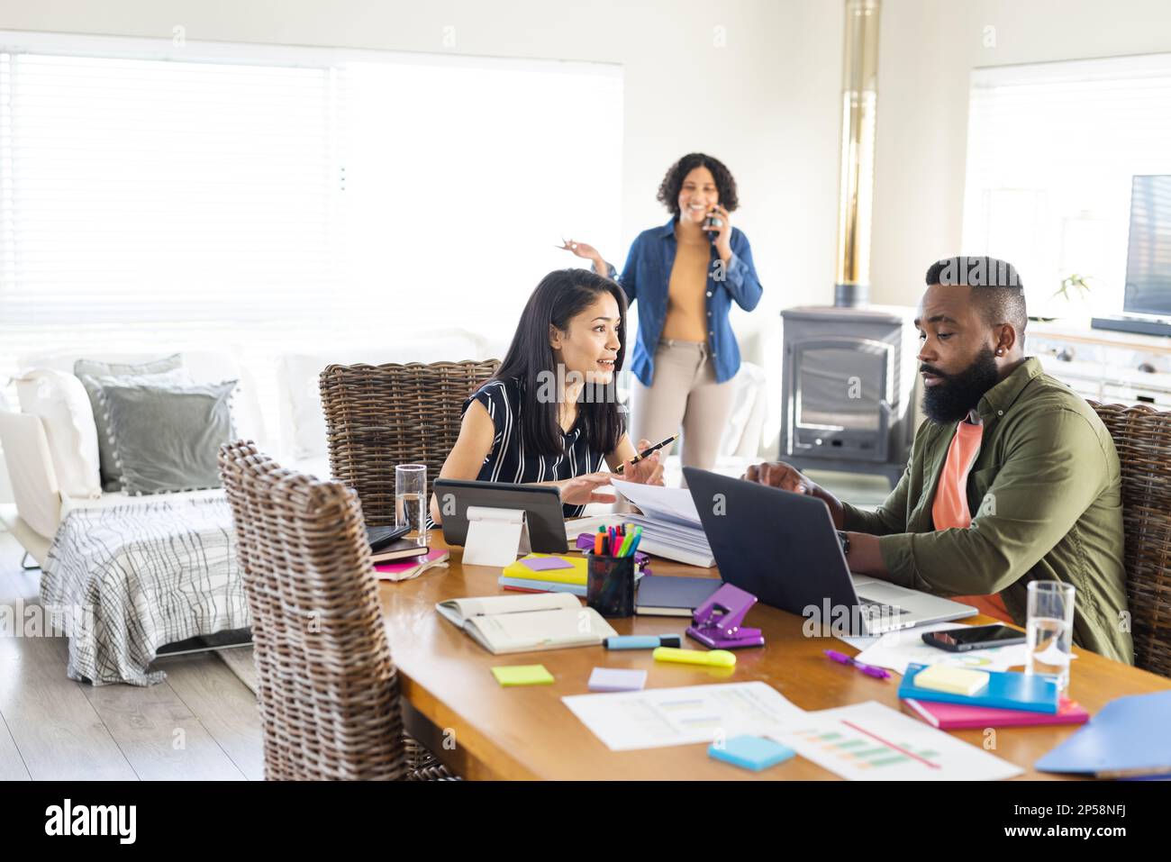 Happy smiling diverse friends working together at home, using ...