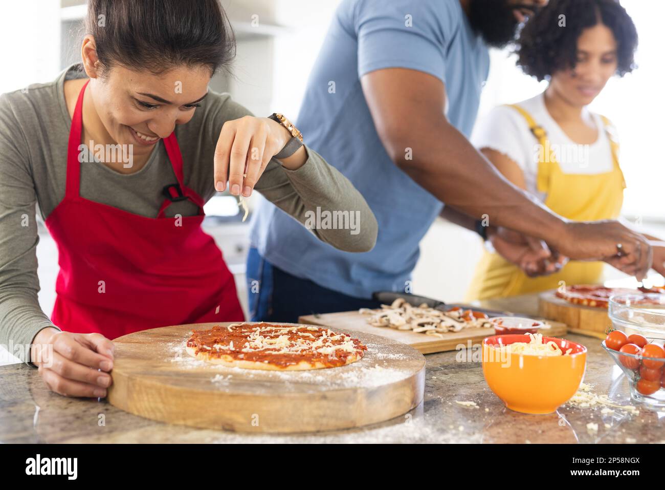 Happy diverse friends cooking together in kitchen Stock Photo - Alamy