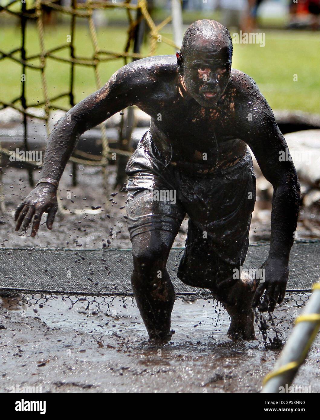 Vanja Kravarusic, 31, from St. Petersburg, is covered in mud as he ...