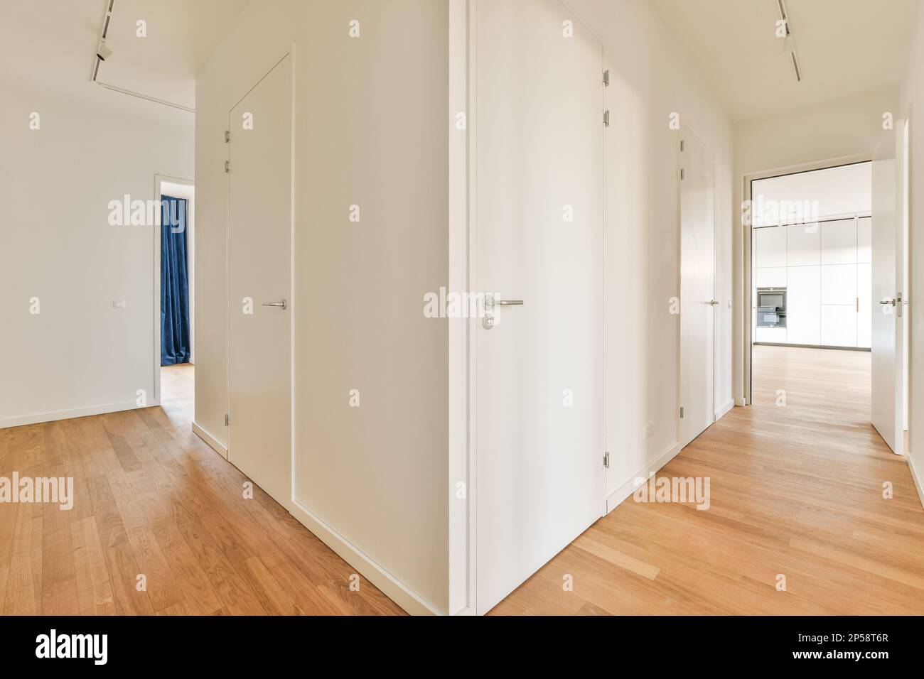 an empty room with white walls and wood flooring on the right, there is ...