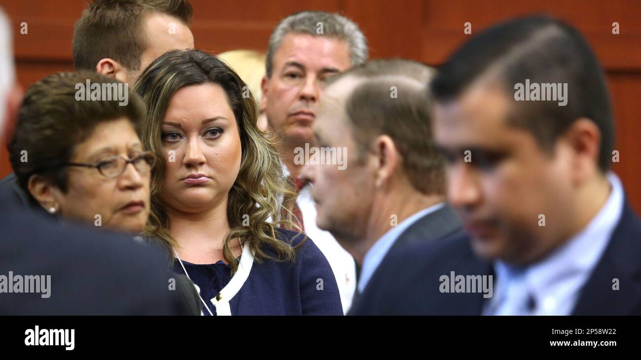 Shellie Zimmerman, center, stands between her husband George Zimmerman ...