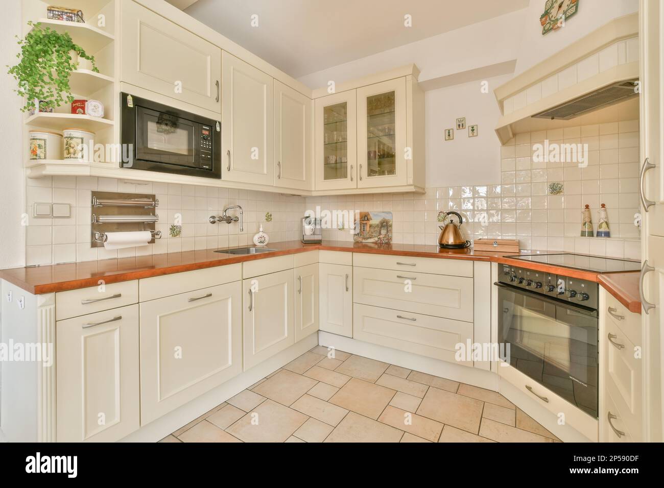 a kitchen with white cabinets and wood counter tops in the center of ...