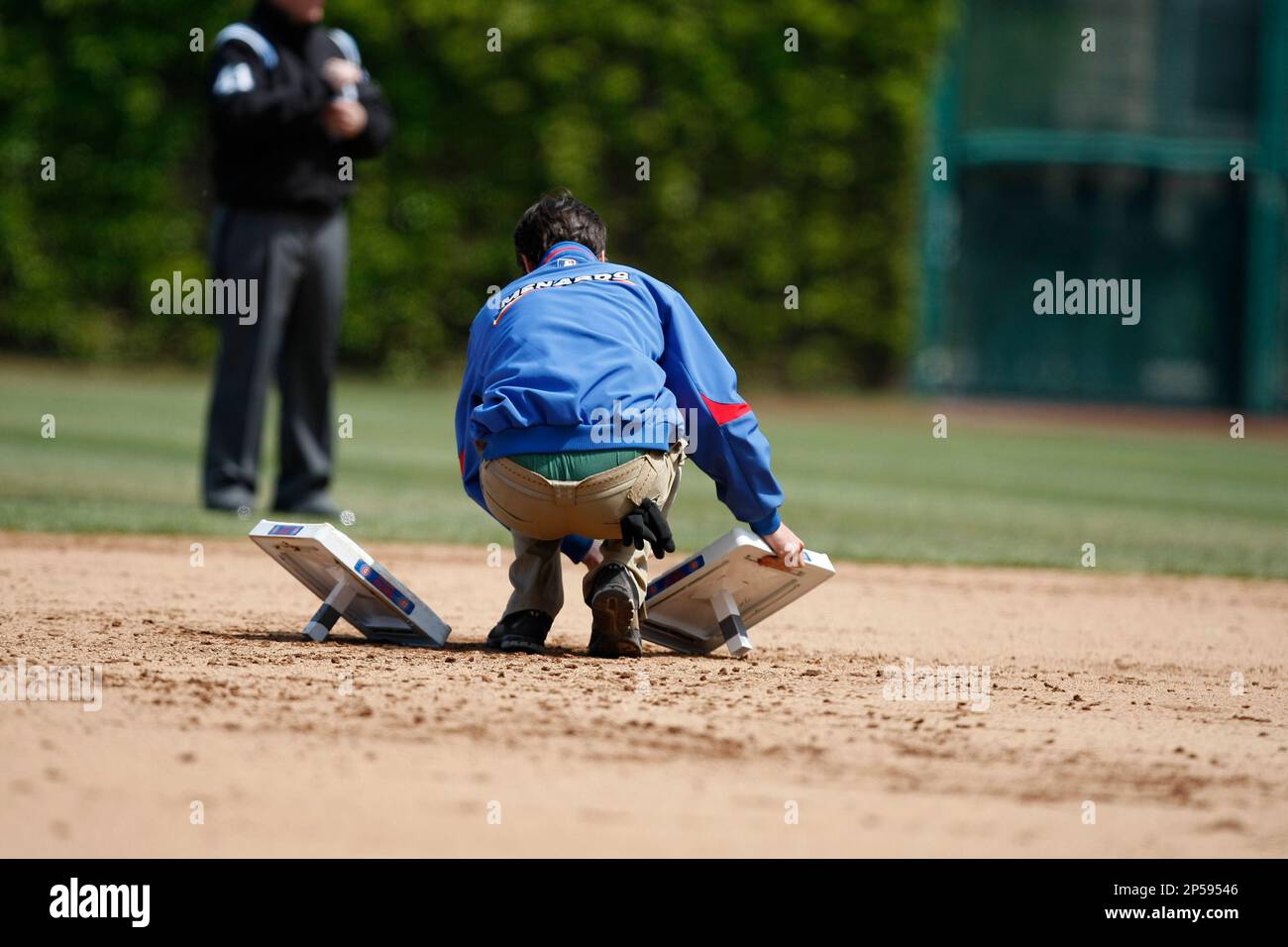 Chicago Cubs grounds crew members prepare the field during the game ...