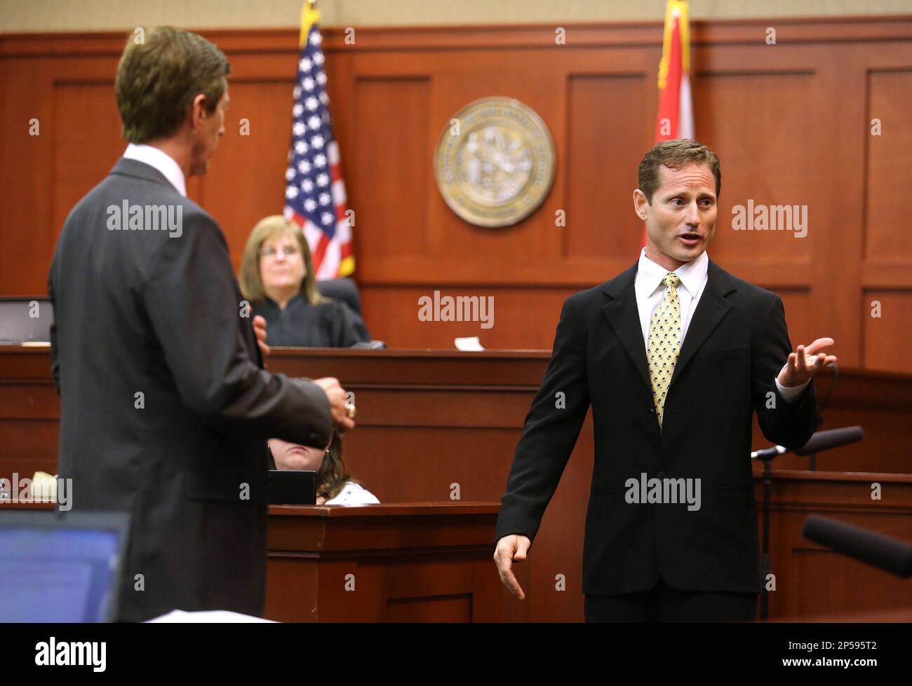 Adam Pollock, right, a central Florida gym owner and trainer, addresses ...