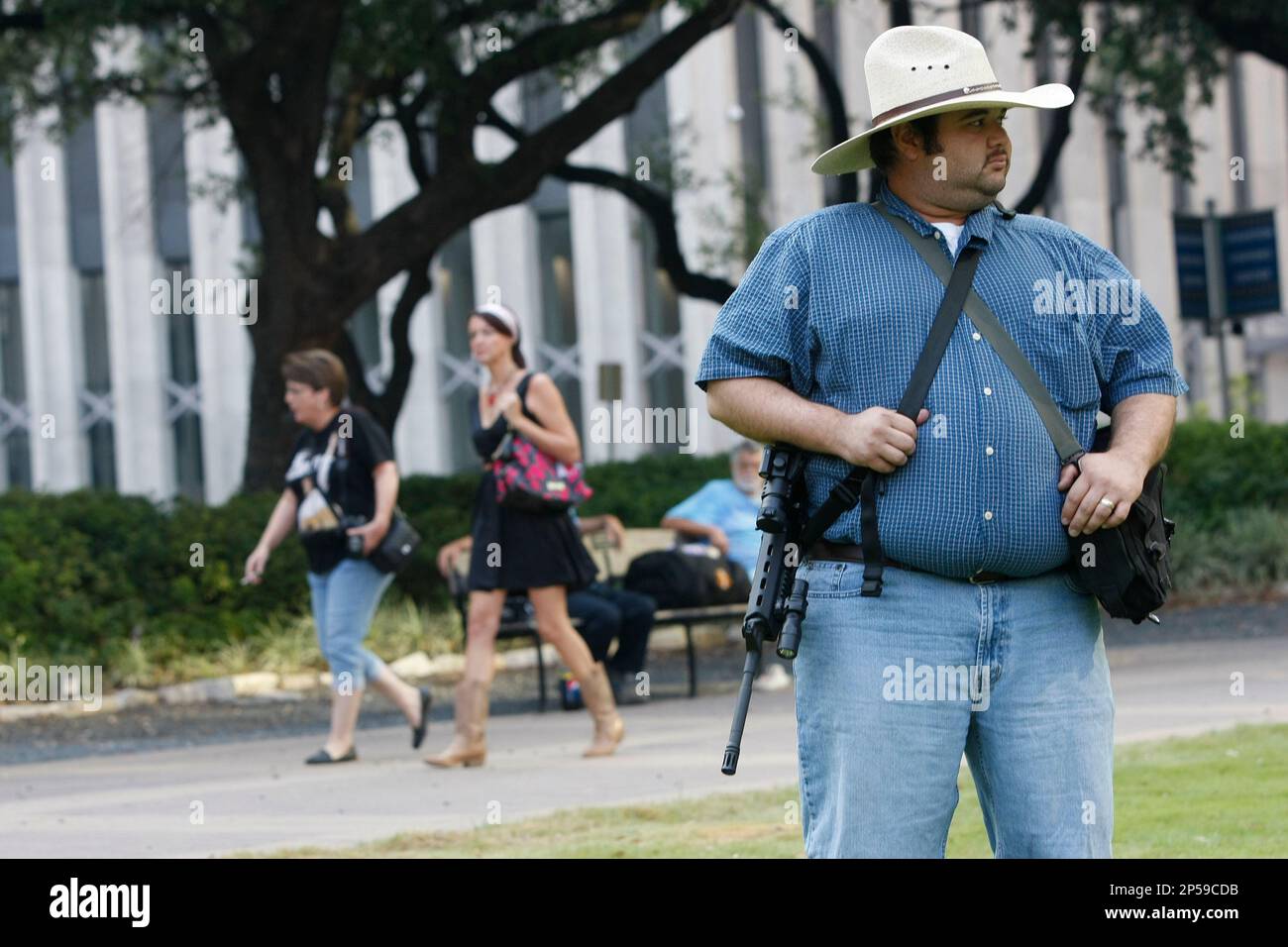 Oscar Garza, 29, of Houston holds his AR-15 rifle as he waits for other ...