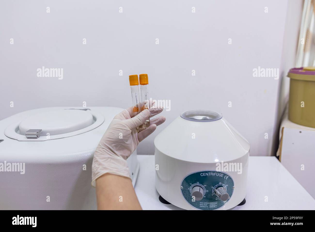 The blood tube is removed from the medical centrifuge for plasma ...