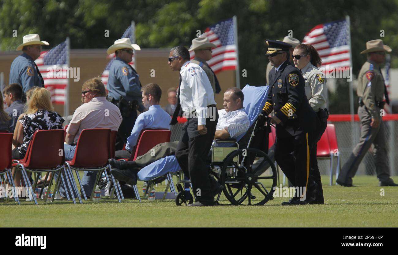 Granbury officer Chad Davis is wheeled by Chief Mitch Galvan to pay his ...