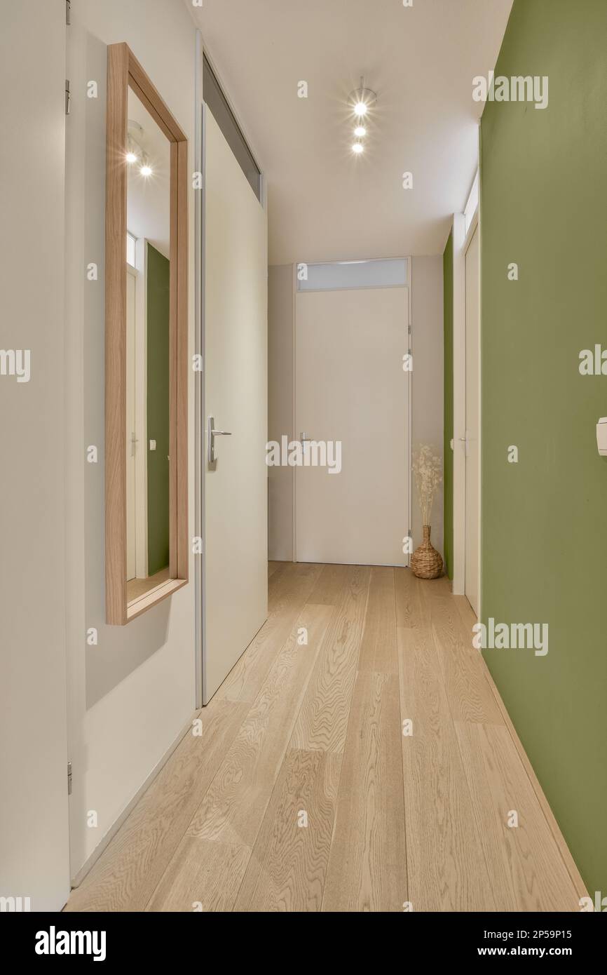 an empty room with green walls and wood flooring on the left side of ...