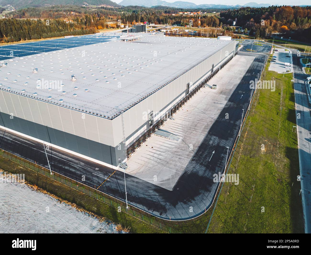 Aerial view of a side of large logistic distribution warehouse in ...