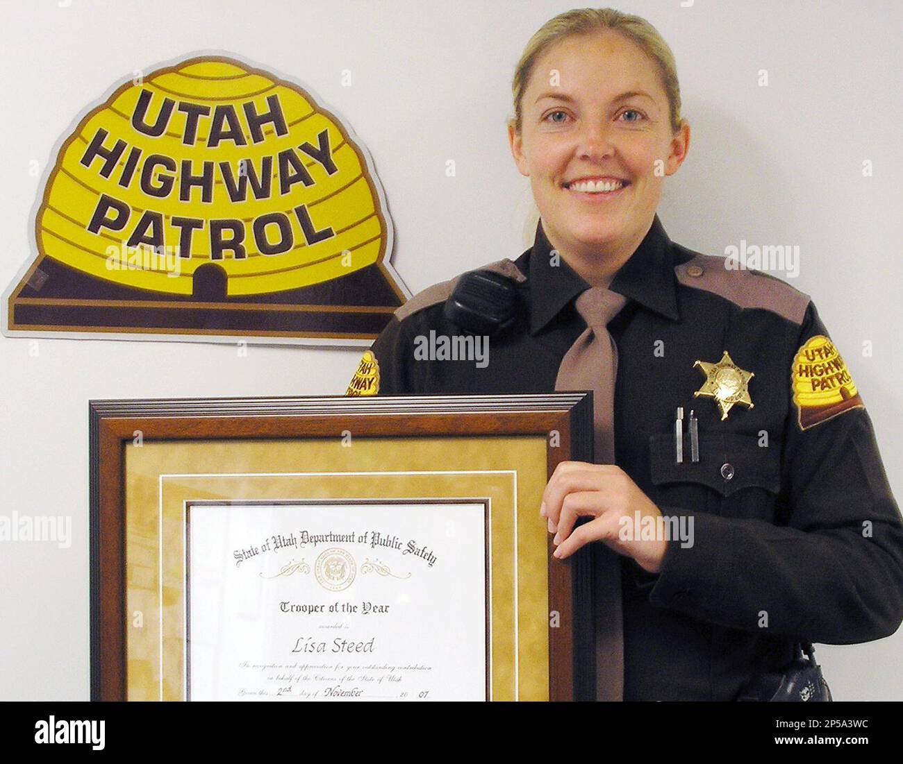 FILE - Utah Highway Patrol Officer Lisa Steed holds her award after ...