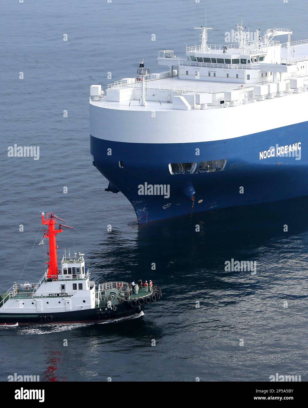A vessel (L below) of Japan Coast Guard (JCG) approaches the Norwegian ...
