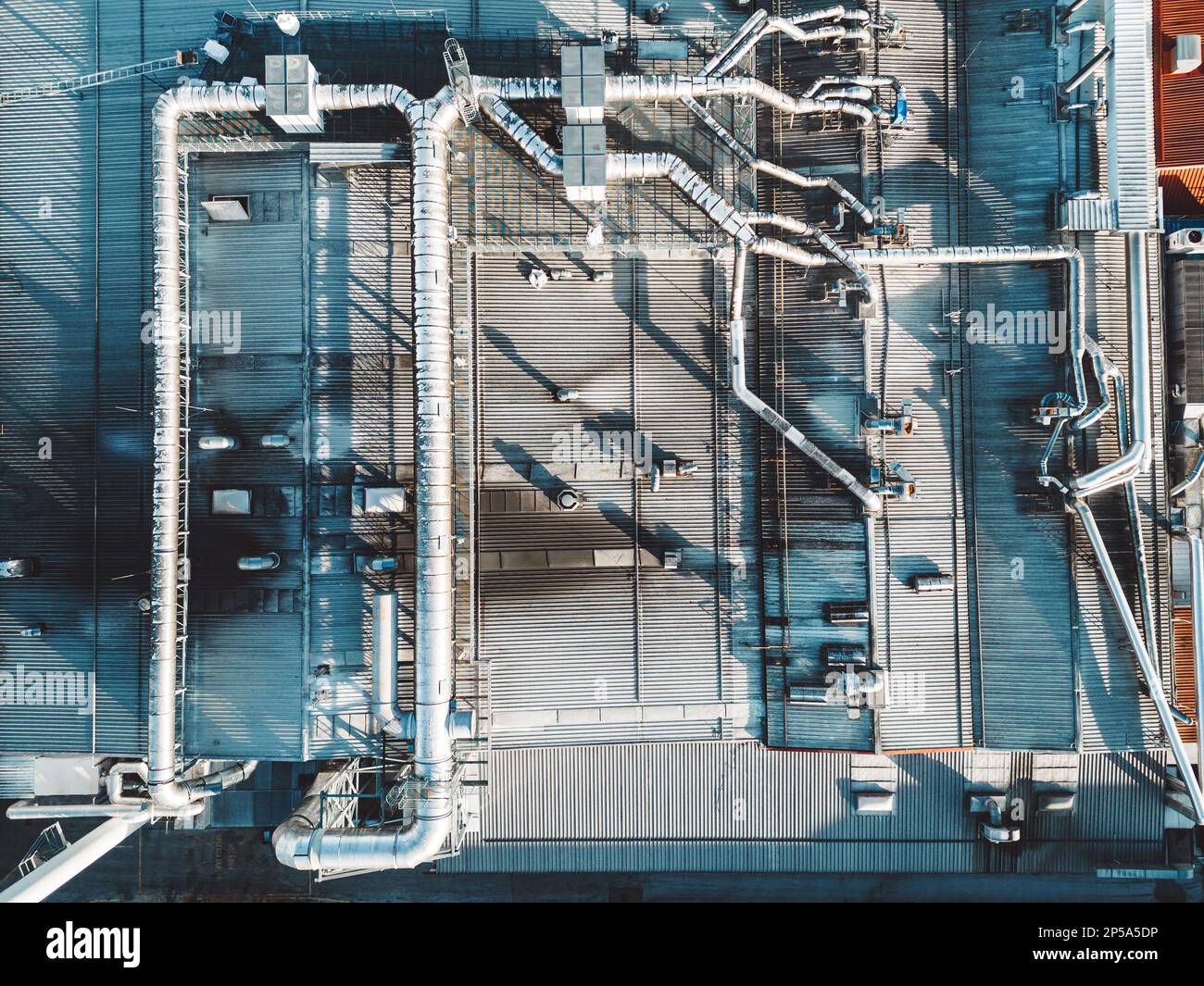 Top down view of pipes going across the roof top of logistics center ...