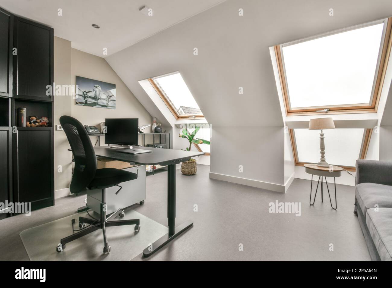 a modern home office with skylights in the windows and an open space to ...