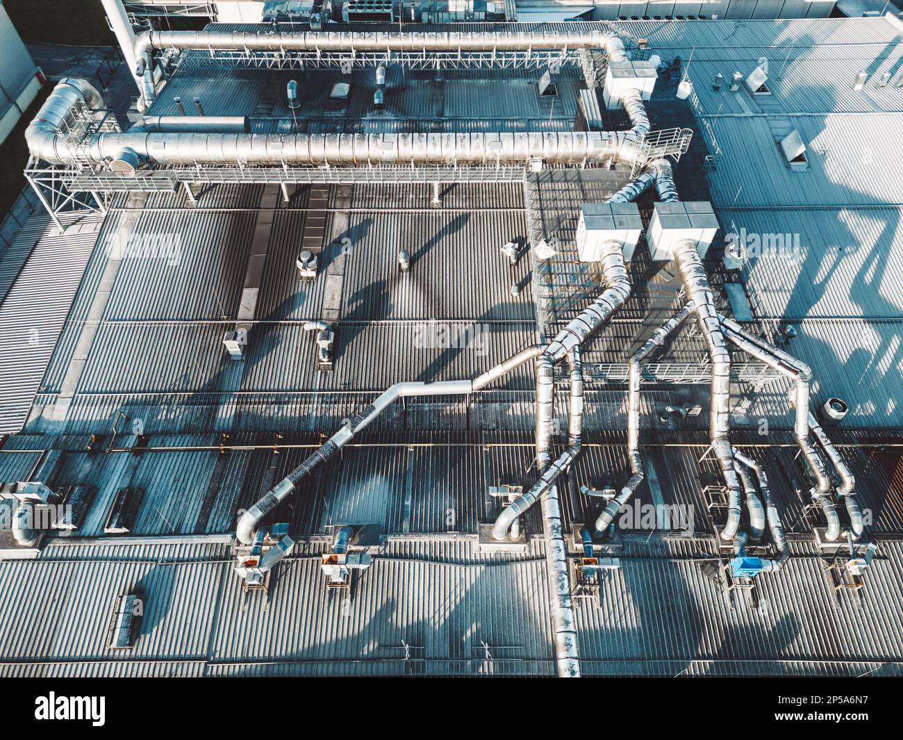 Directly above a roof top of an industrial building with ventilation ...