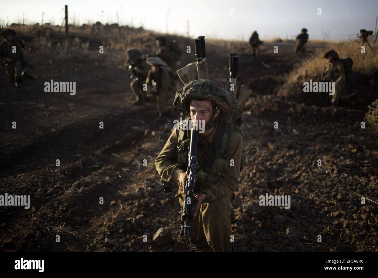Israeli soldiers of the Golani brigade take position during training in ...