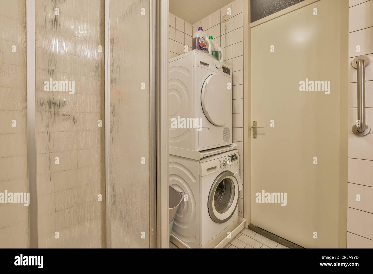 a laundry room with a washer and dryer on the wall next to an open door ...